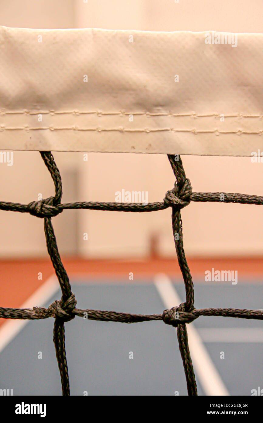 Tennis net at indoor tennis court building Stock Photo - Alamy