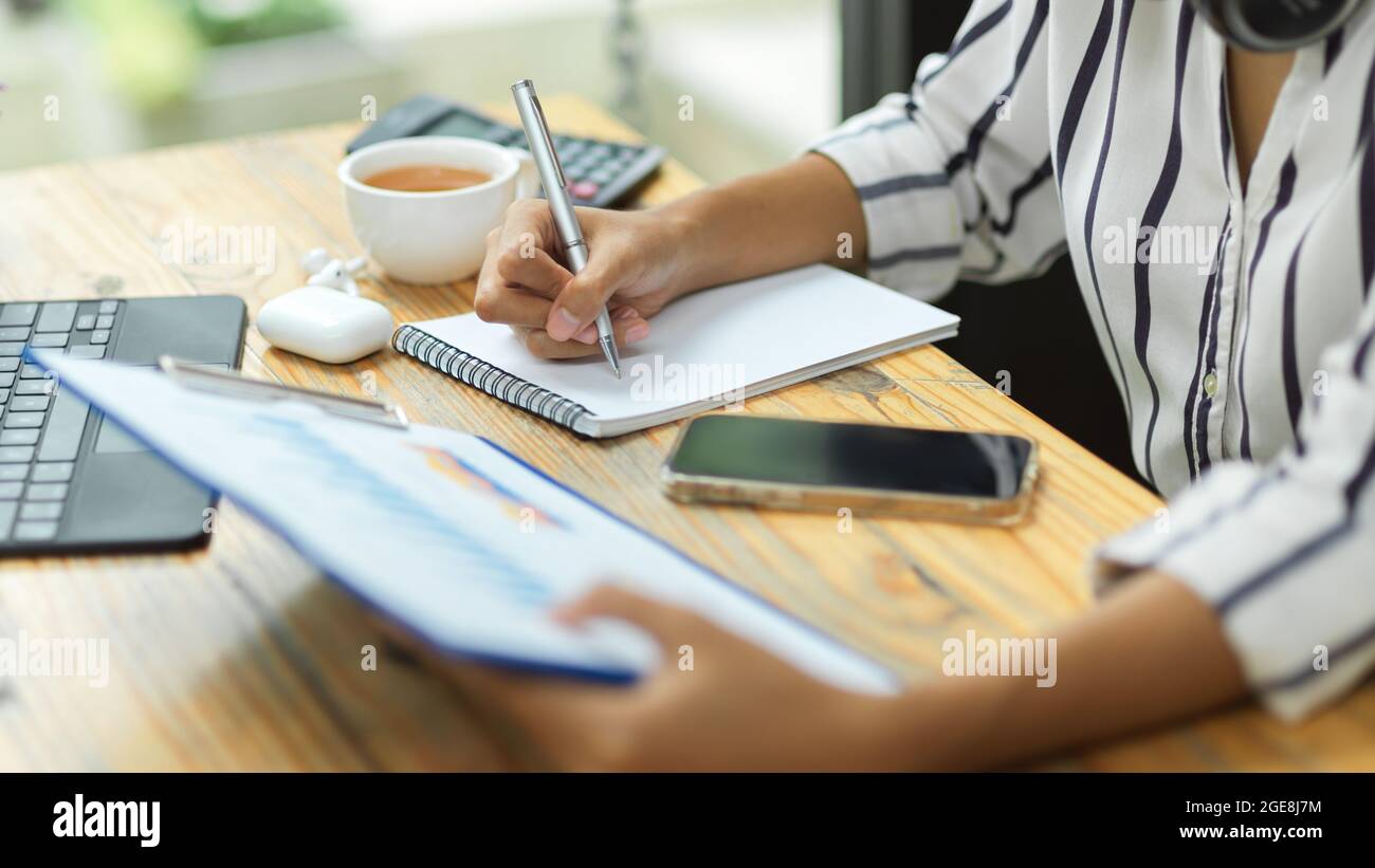 Businesswoman taking notes, planning business model from financial ...