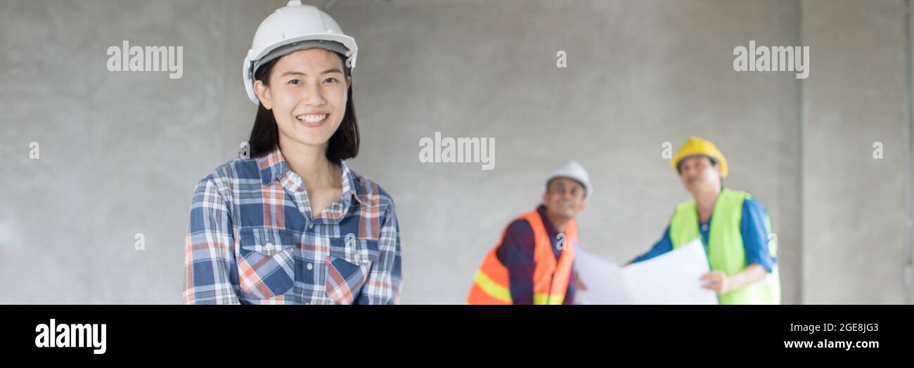 portrait of engineering women at construction site with worker working ...