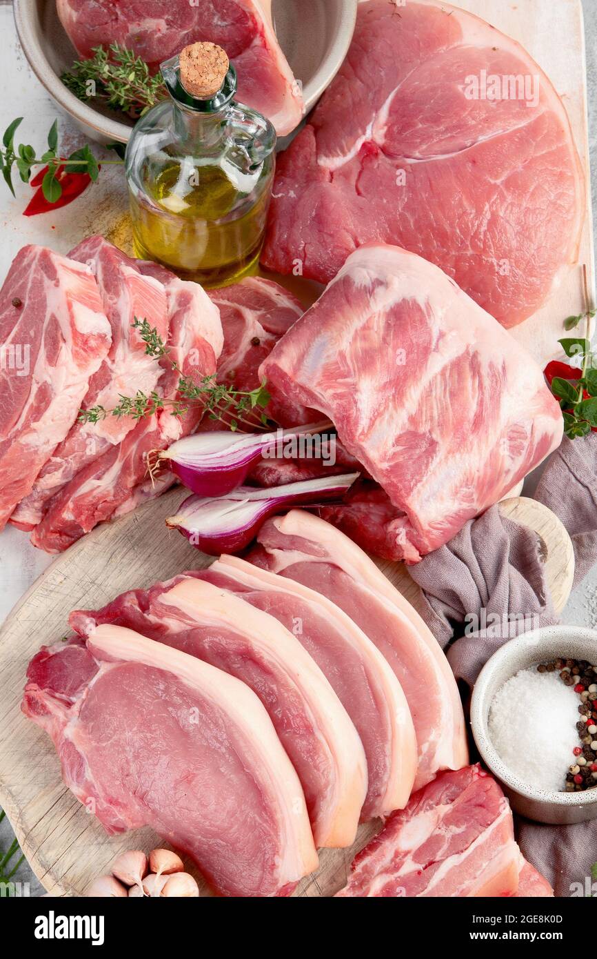 Assortment of raw pork meat on light grey background. Organic gourmet ...