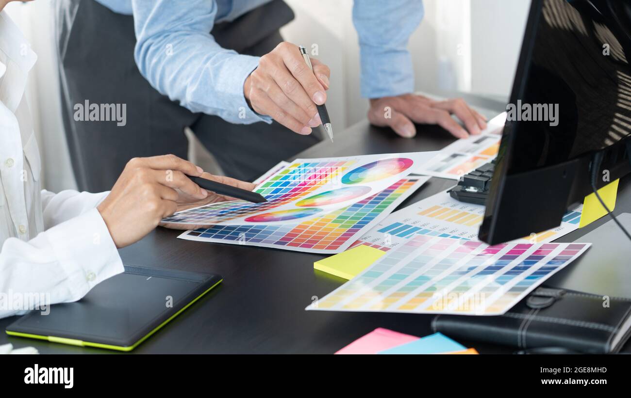 graphic designer team working on web design using color swatches ...