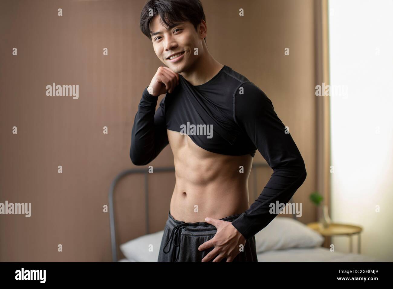 Young Chinese man getting up for morning exercises Stock Photo - Alamy