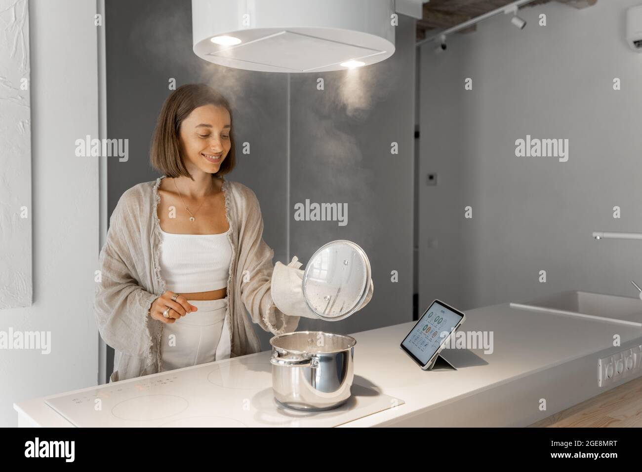 Woman cooking at modern kitchen Stock Photo - Alamy