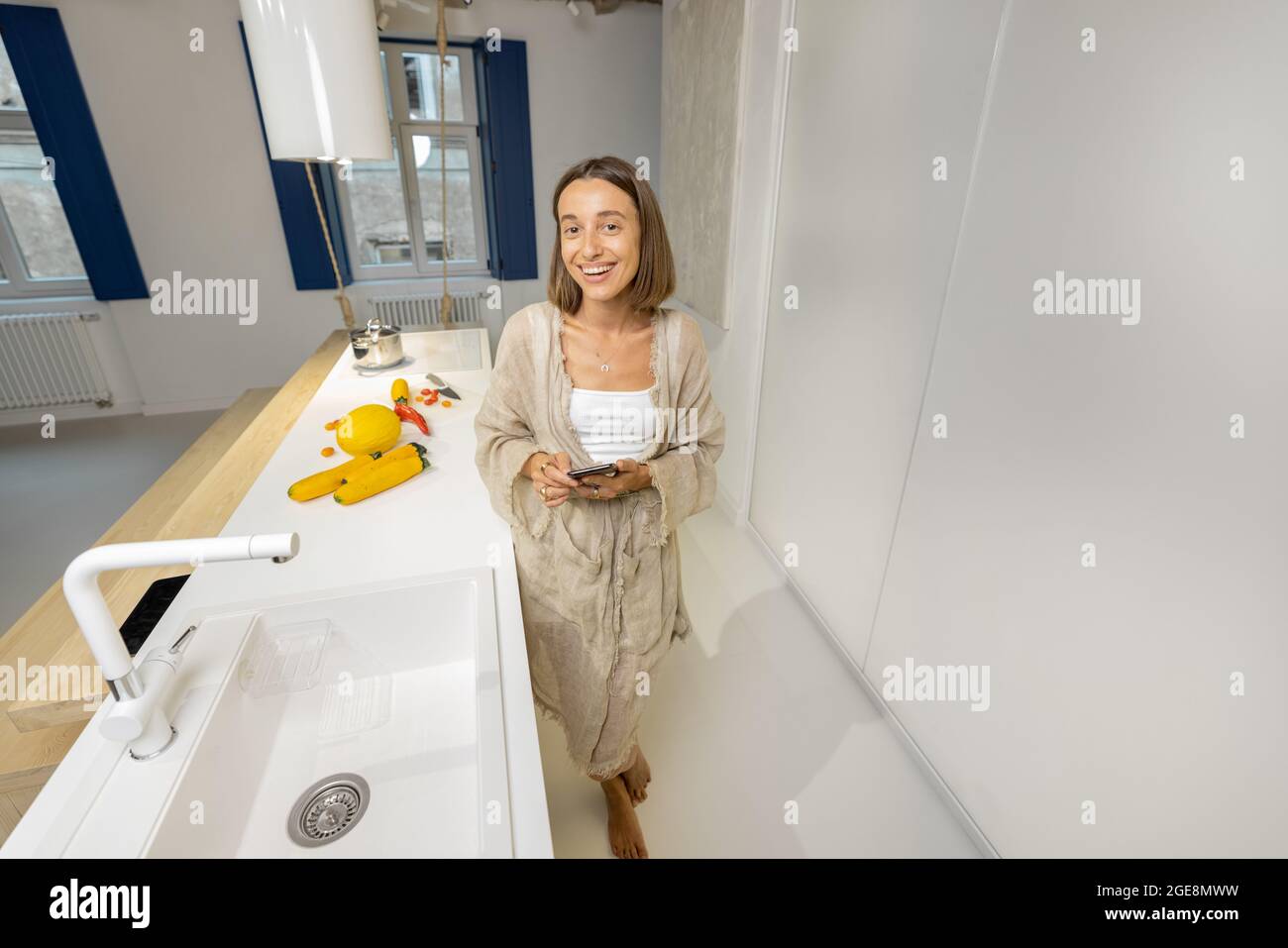 Woman with healthy food ingredients at modern kitchen Stock Photo - Alamy