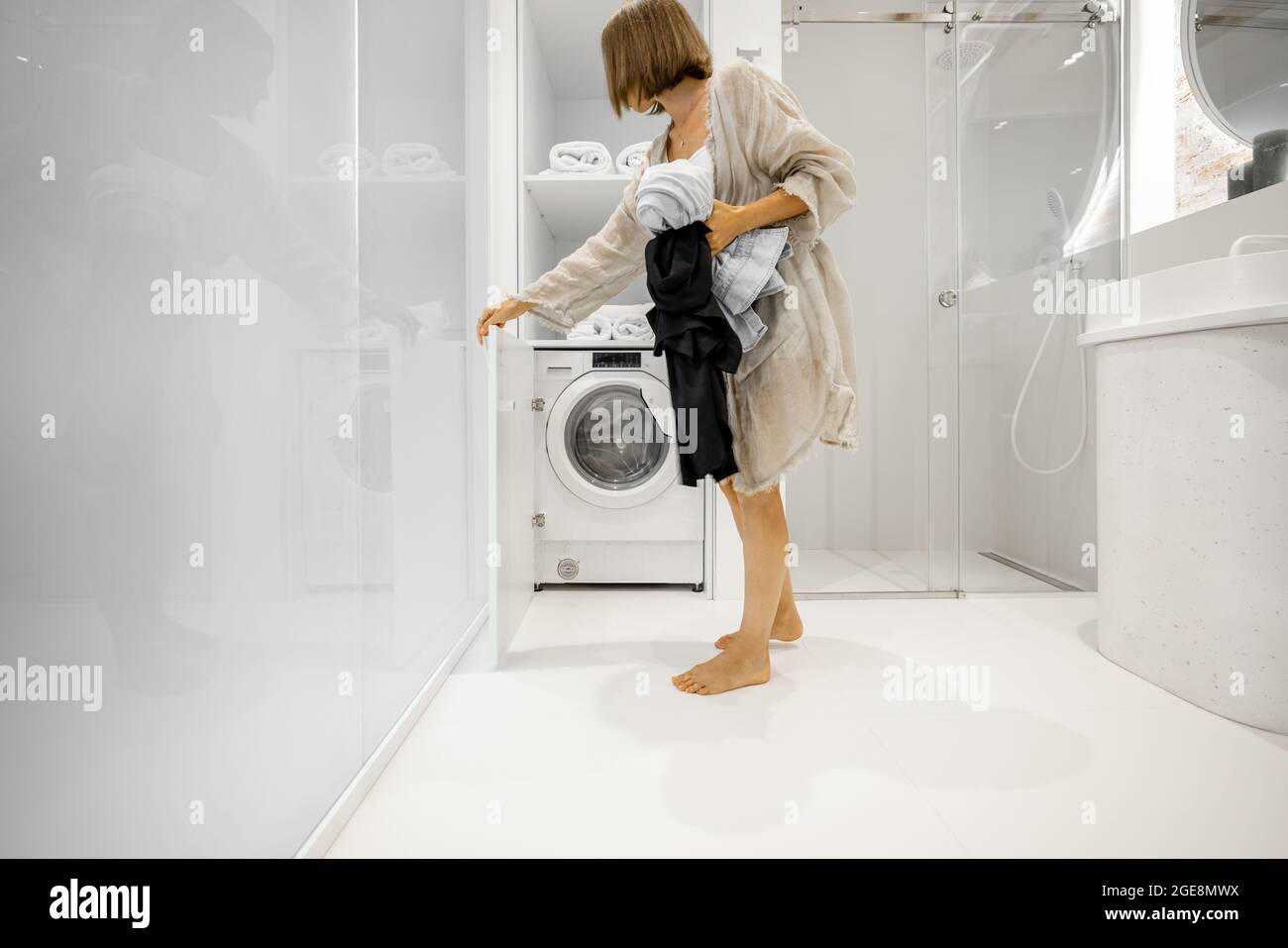 Woman washing clothes at home Stock Photo - Alamy