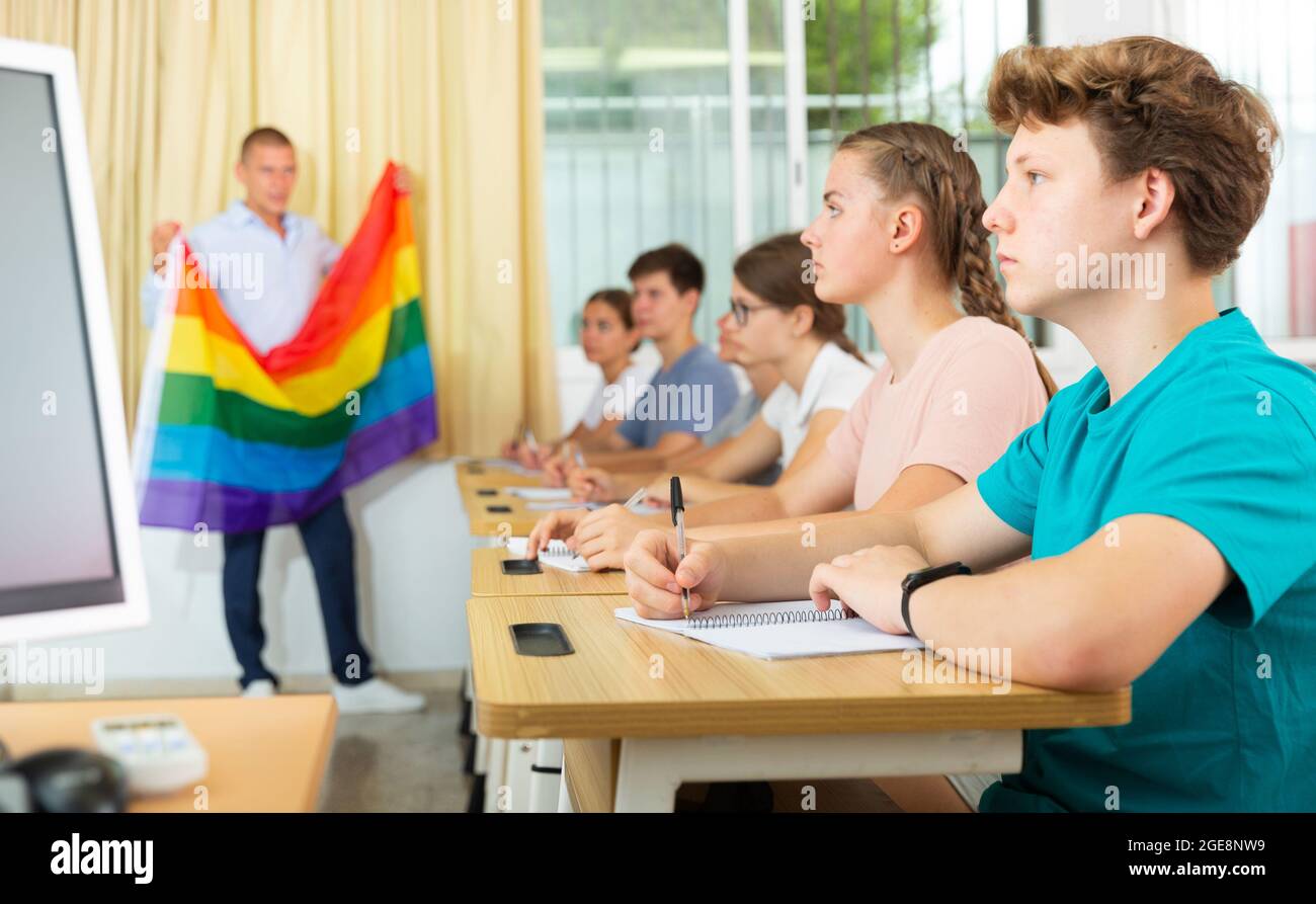 School teacher with flag explains to students what is LGBT Stock Photo ...