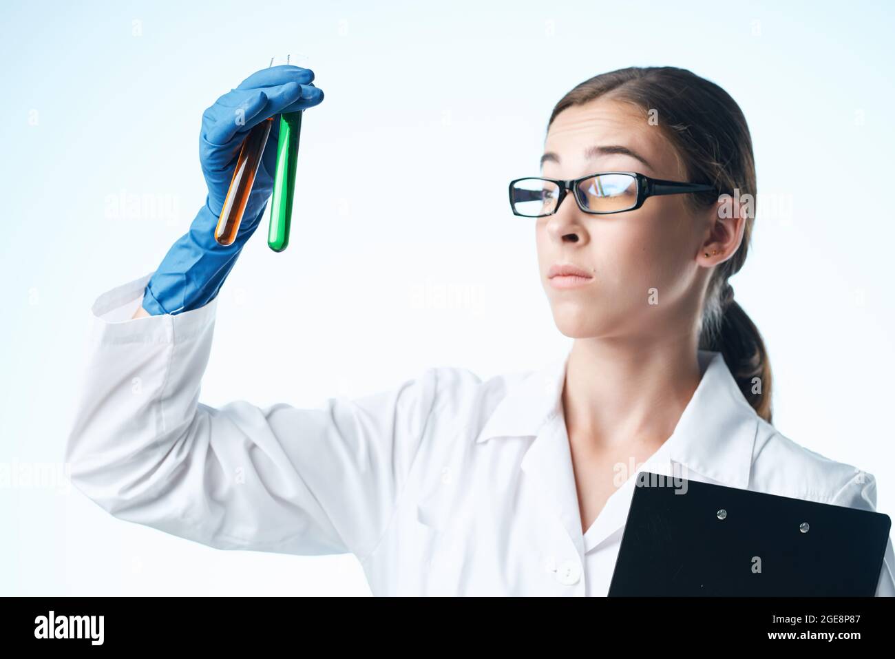 female laboratory assistant in white coat chemical solution research ...