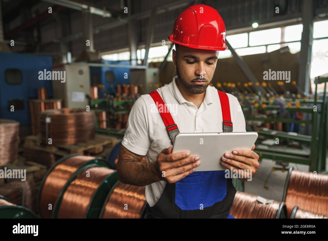 African american male manager in electric cable warehouse holding ...
