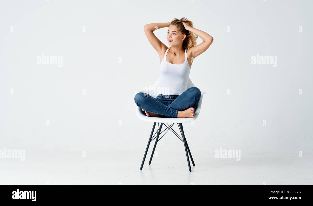 woman sitting on chair bent legs lifestyle isolated background Stock ...