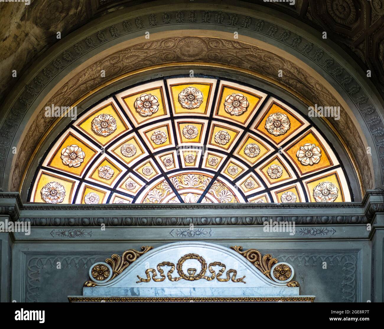 artistic stained glass window with floral motifs inside an ancient ...