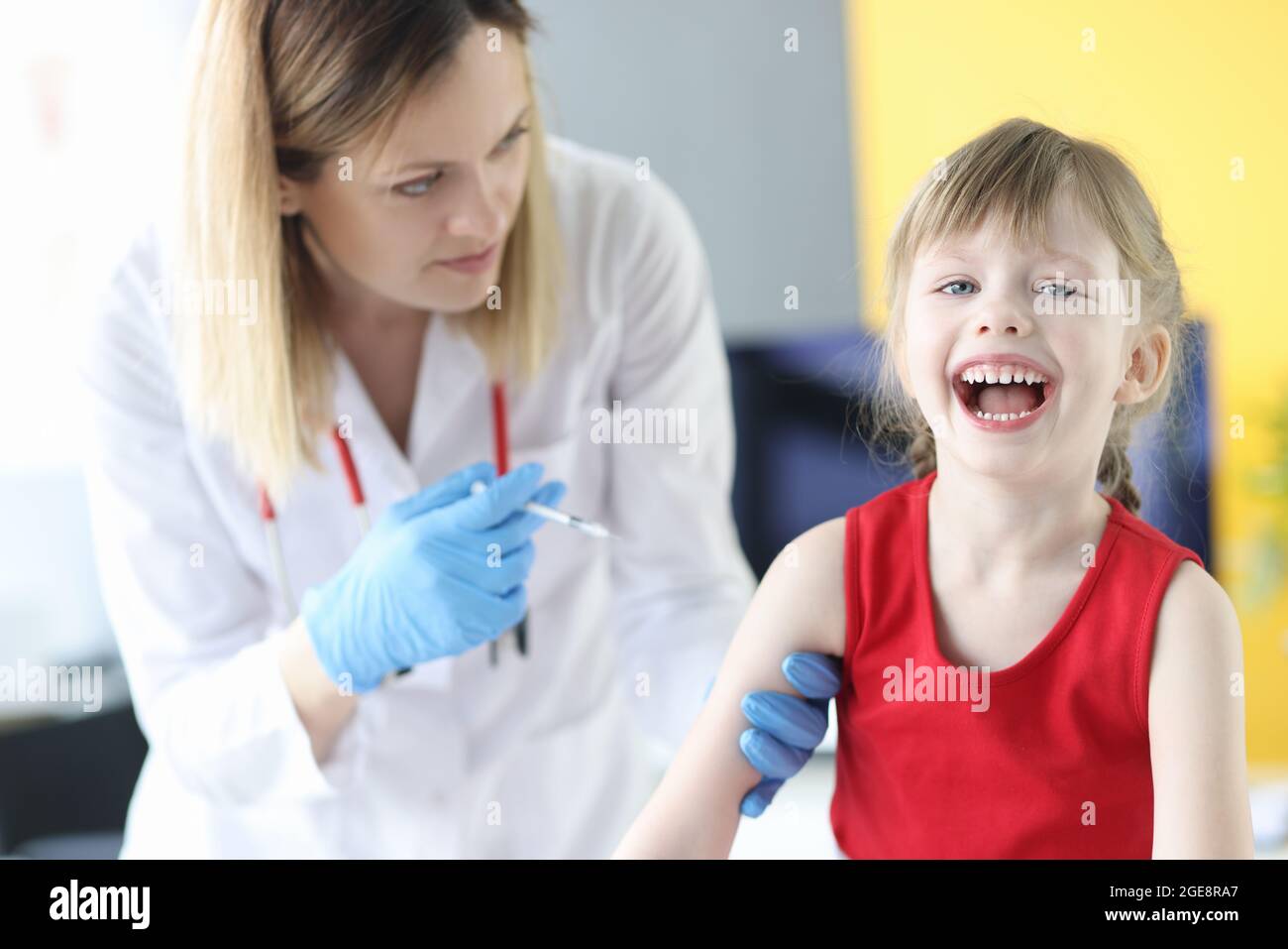 Doctor gives little girl injection in shoulder closeup Stock Photo - Alamy