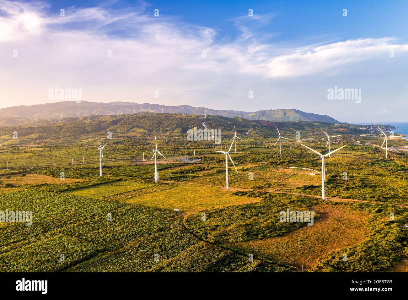 Landscape of windmills on farm fields covered in greenery under the ...