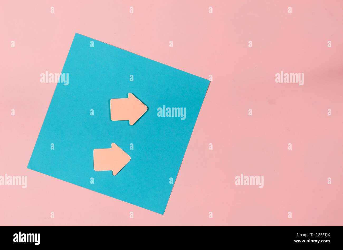 Sheet of paper and bookmark arrows on a pink background. Blue square ...