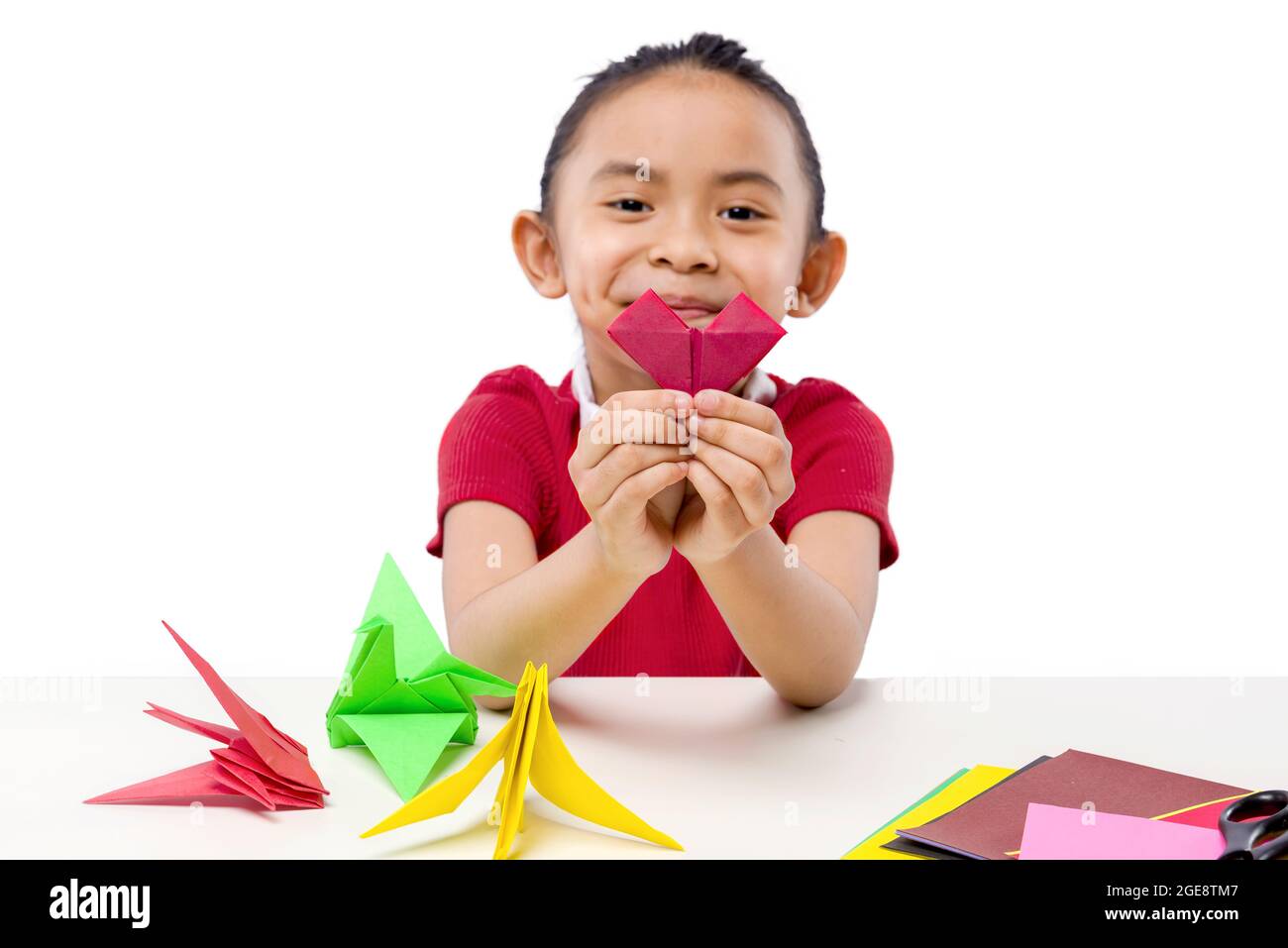 Asian little girl showing her papercraft isolated over white background ...