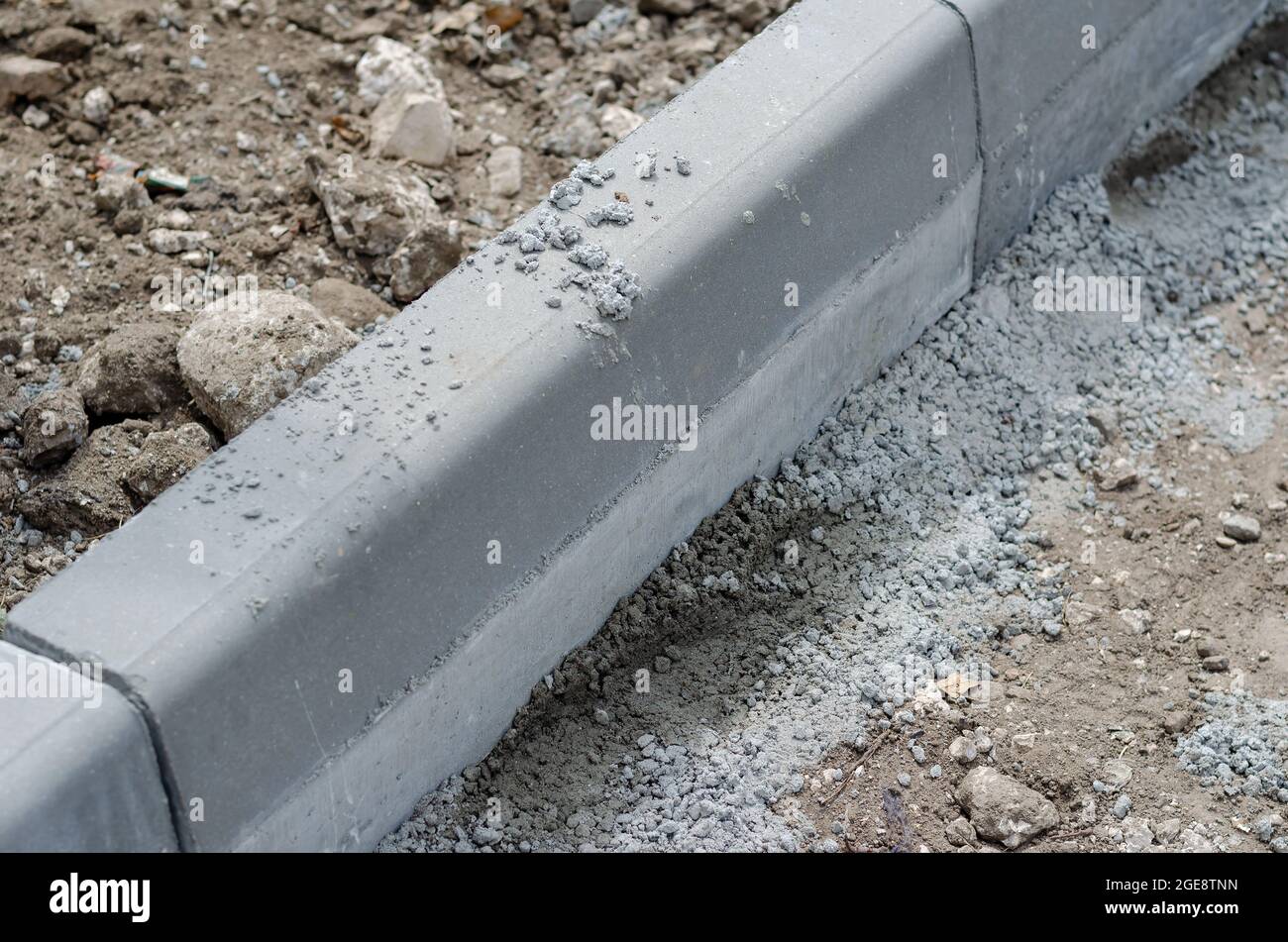 Installation of new curbs. The gray curbs are fixed in cement mortar ...