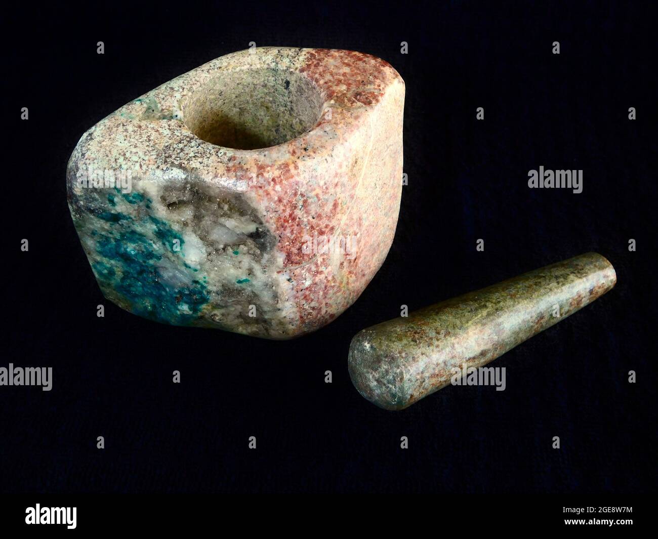 Closeup of a kitchen mortar and pestle isolated in the black background ...