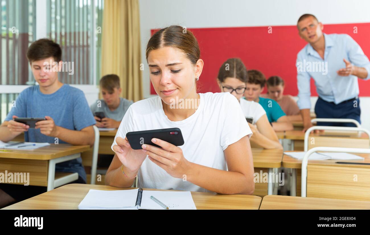 Girl high school student using mobile phone on lecture in class Stock ...