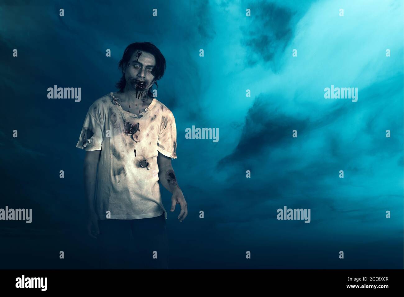 Scary zombie with blood and wound on his body standing with a night ...