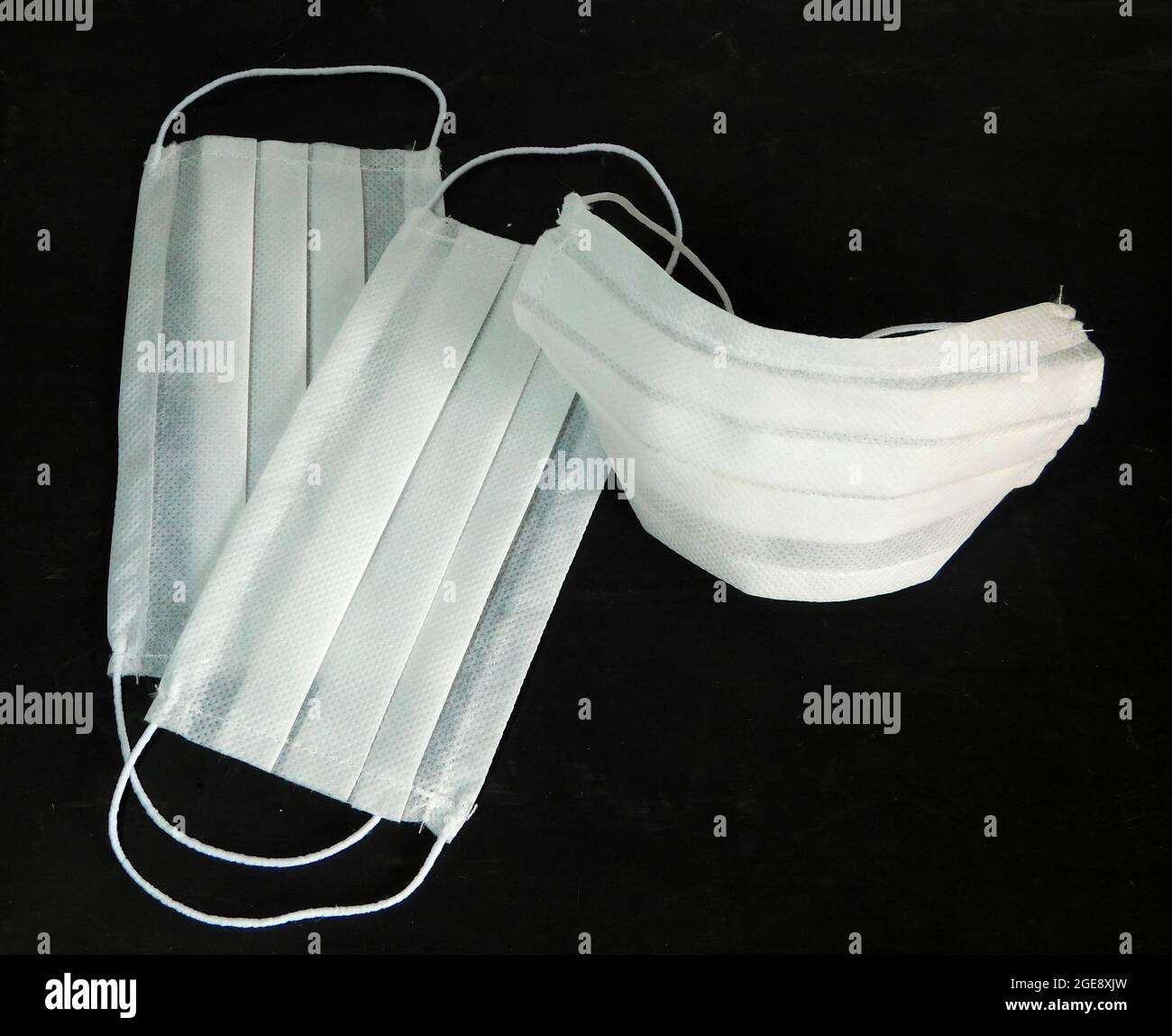Disposable medical masks isolated in the black background Stock Photo ...