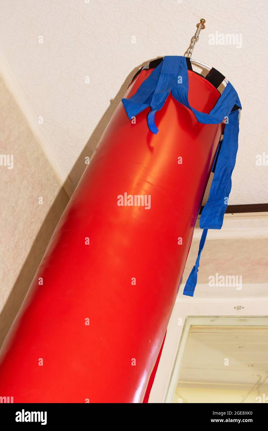 Punching bag hanging from the ceiling close up Stock Photo - Alamy