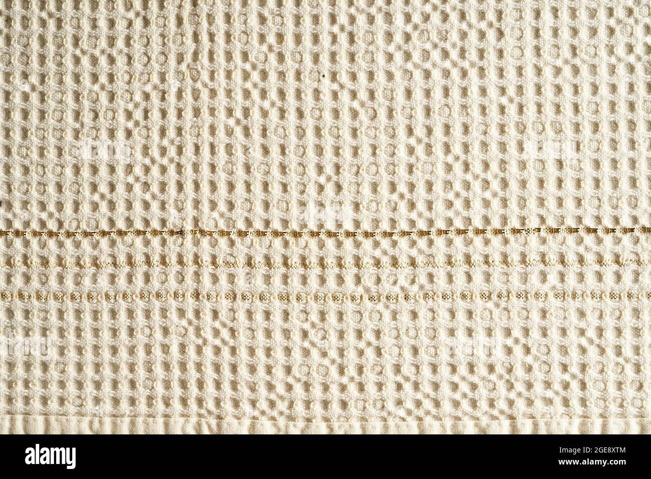 Closeup of a rough textured paper with golden thread for background or ...