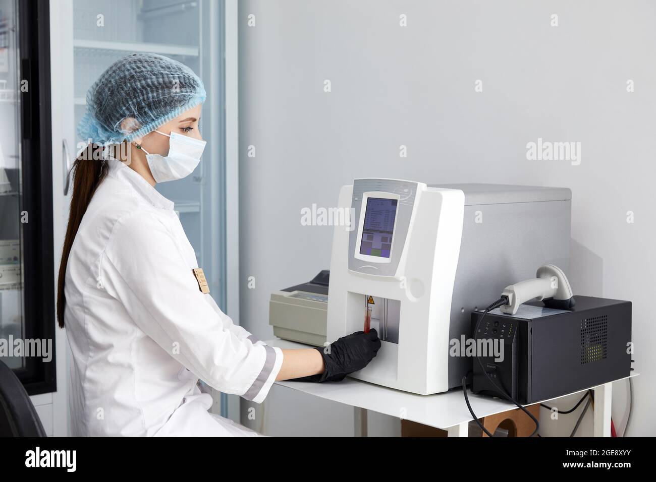 Female Research Scientist Putting Test Tube with Blood Sample into ...