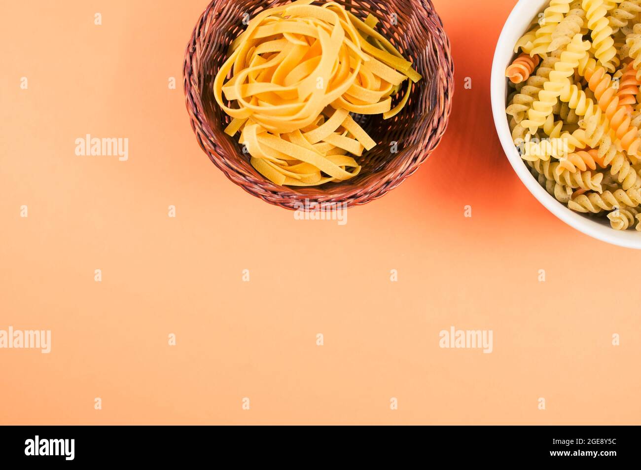Top view of tri-color rotini and fettuccine pasta on a bowl isolated on ...