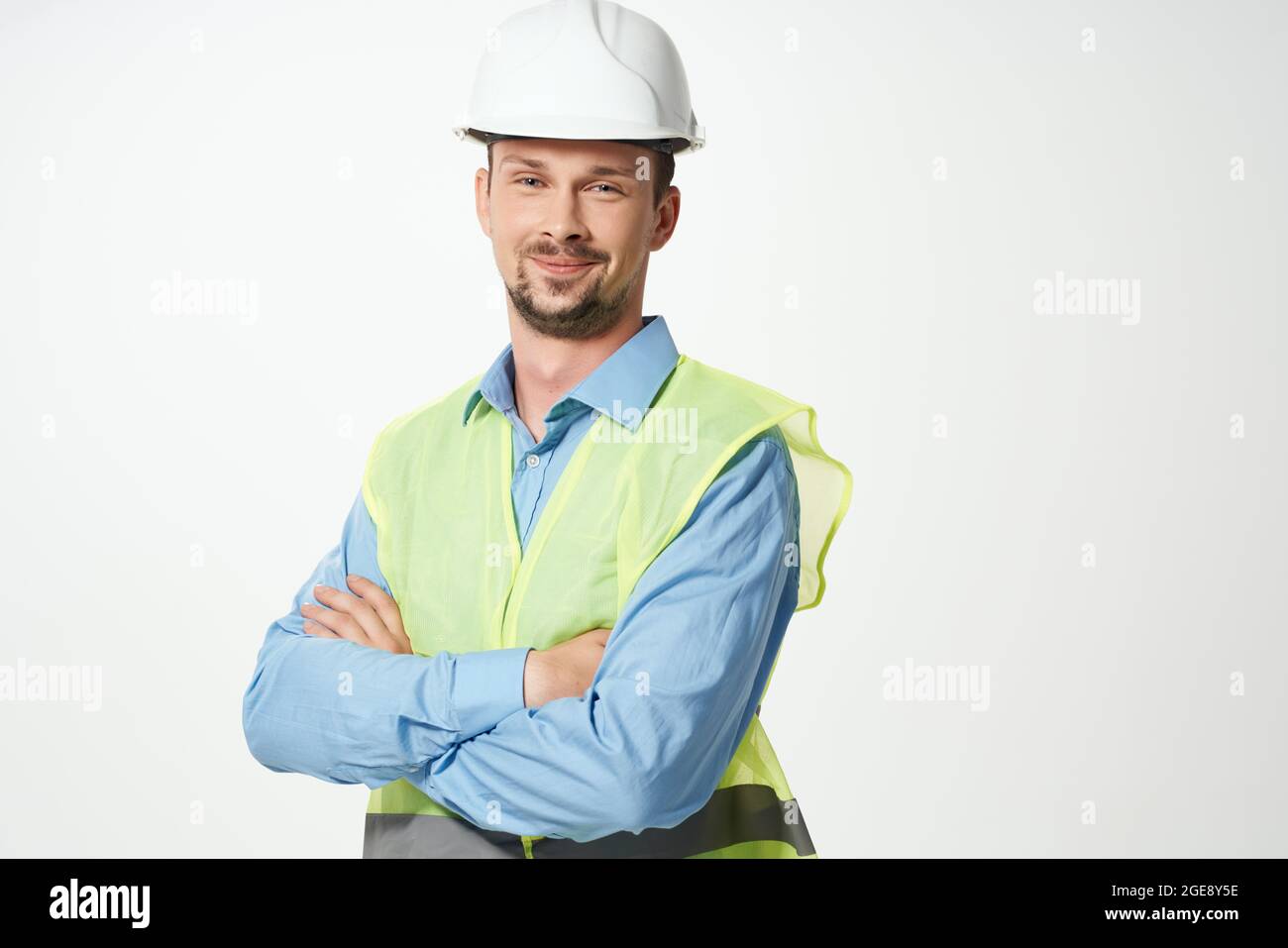 Male builder Professional working uniform light background Stock Photo ...