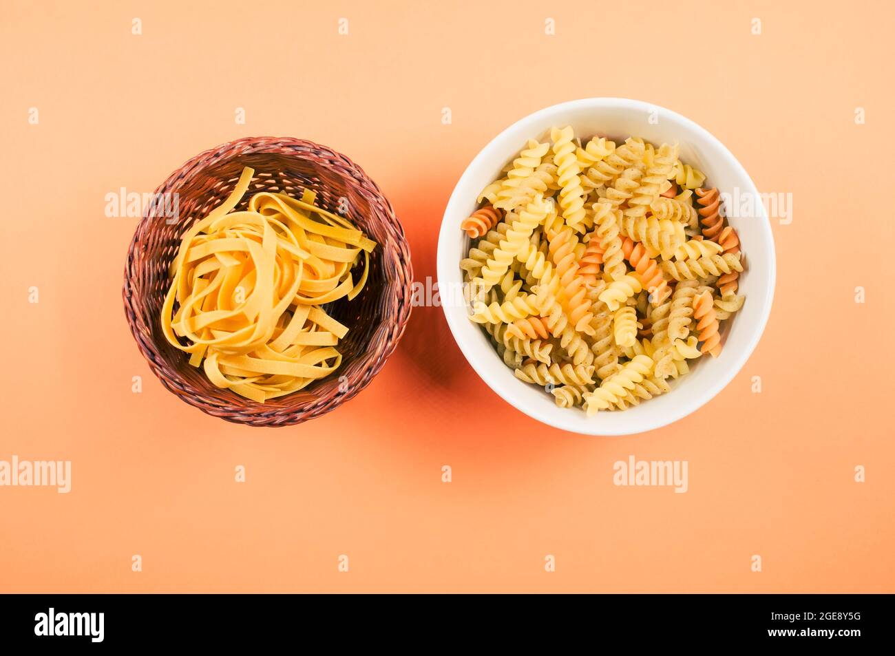 Top view of tri-color rotini and fettuccine pasta on a bowl isolated on ...