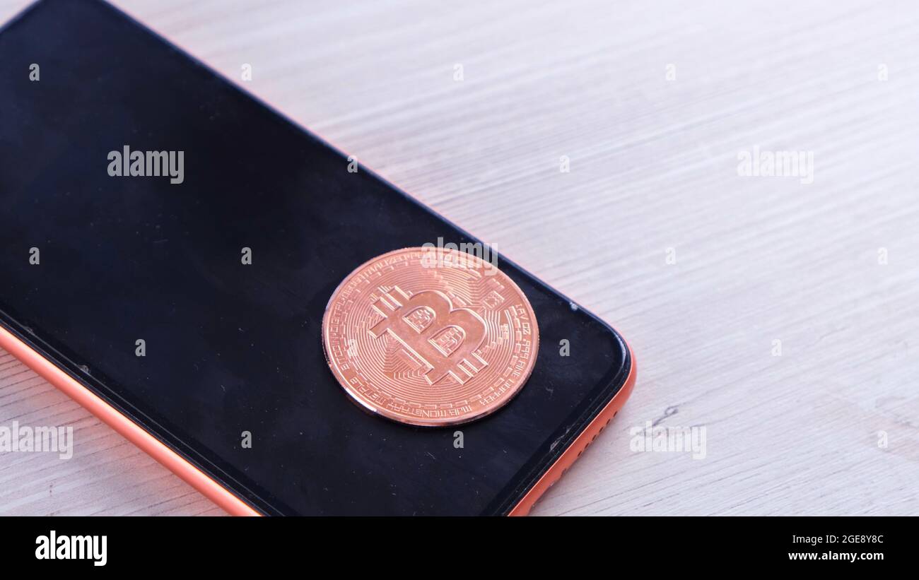 smartphone with bitcoin coin for shopping on a light background. Online ...