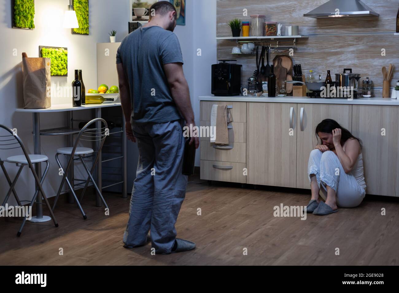 Domestic violence victim sitting on floor because of social problems ...