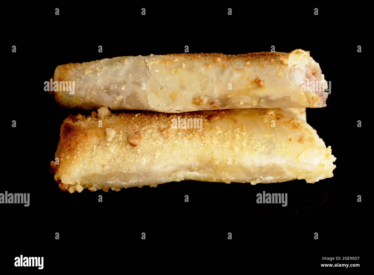 Two homemade apple mini strudel, close-up isolated on black Stock Photo ...