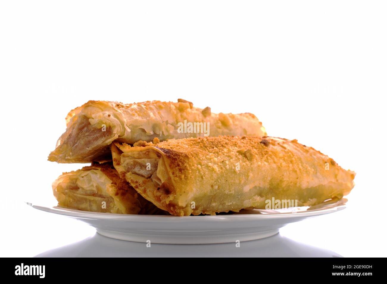Homemade apple mini strudel in a white dish, close-up, isolated on ...