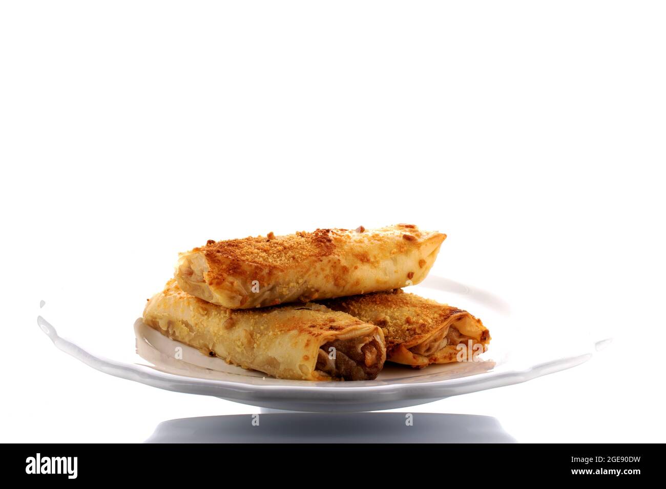Homemade apple mini strudel in a white dish, close-up, isolated on ...