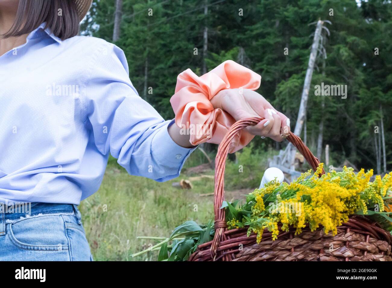 View of a female carrying a basket of flowers with a beautiful scrunchy ...