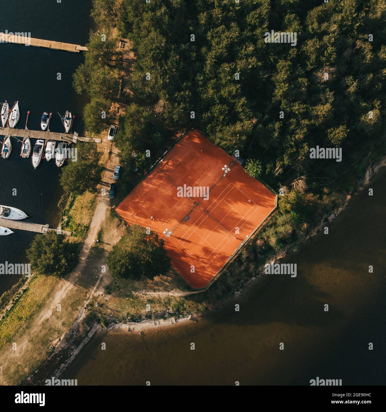 Aerial top view of an empty tennis court on port with boats Stock Photo ...
