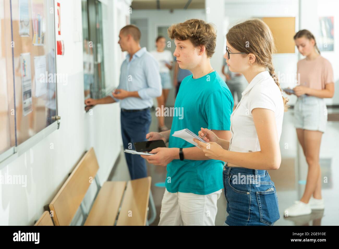 Students record and photograph class schedules in college lobby Stock ...