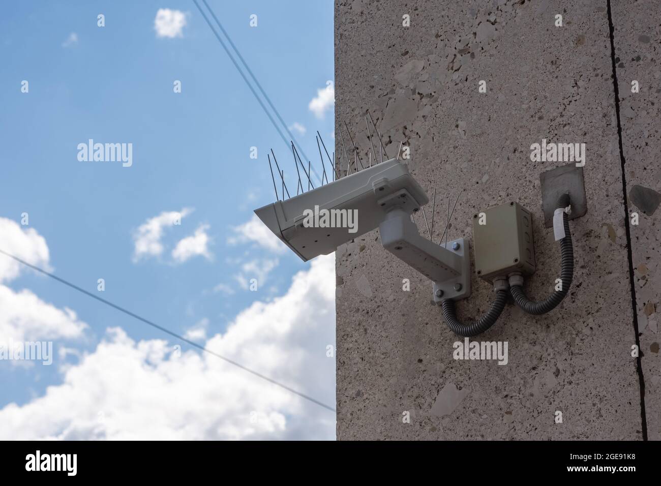 Low angle shot of an outside camera on a corner wall of a building ...