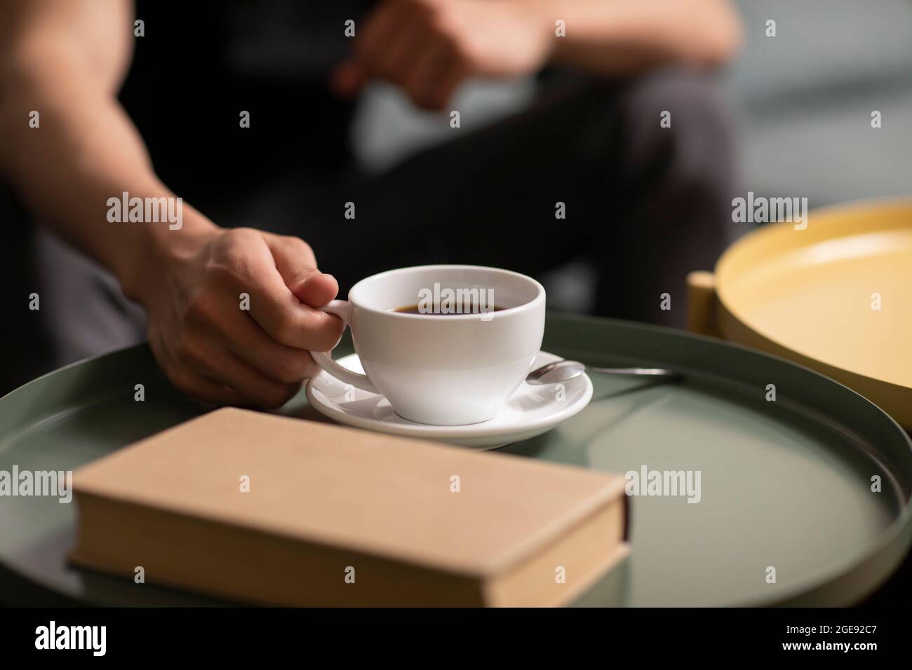 Young Chinese man drinking coffee at home Stock Photo - Alamy