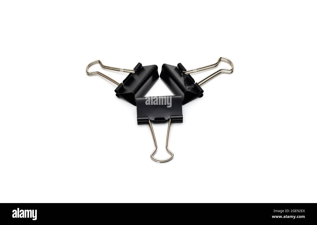 Organized three black metal binder paper clips on isolated white ...