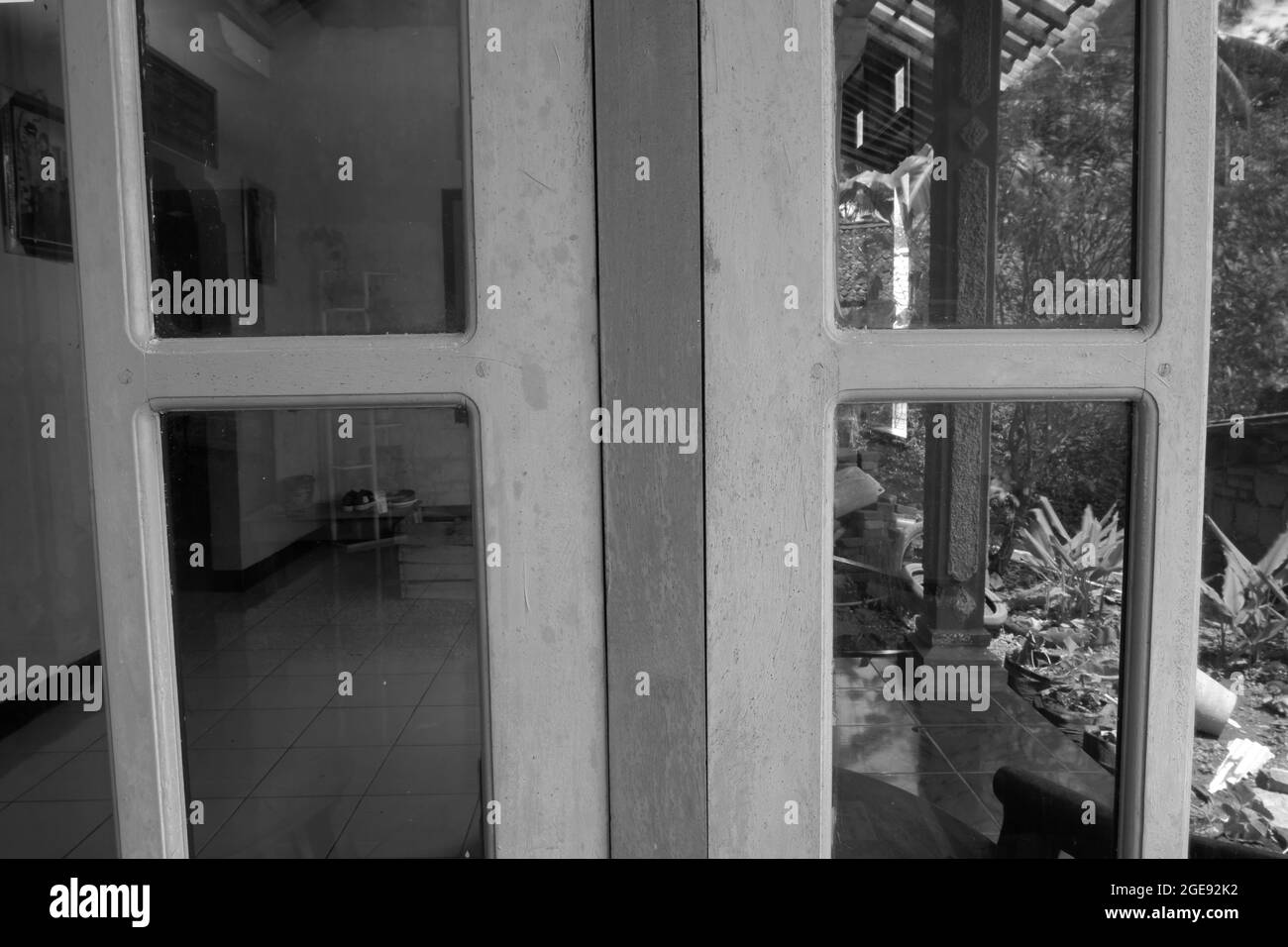 Grayscale shot of wooden window frames of a house Stock Photo - Alamy