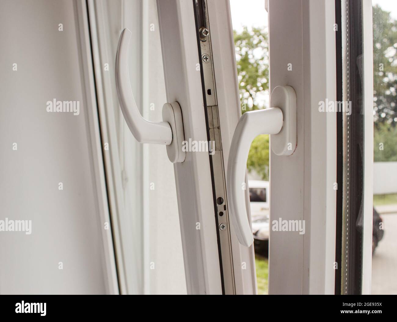 handles of opened white plastic window indoor closeup Stock Photo - Alamy