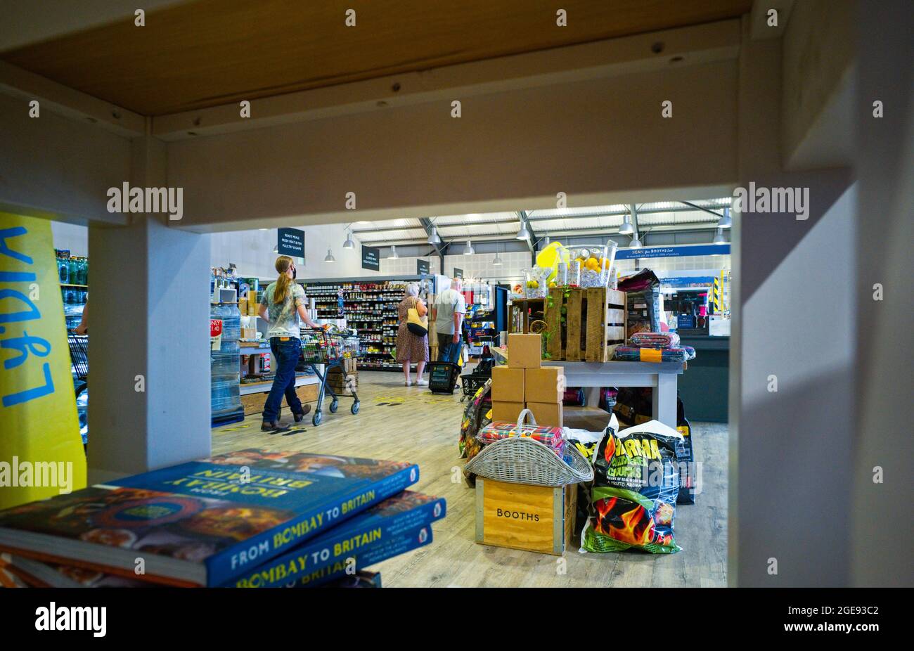 Looking through bookshelves into the main supermarket at Booths in ...