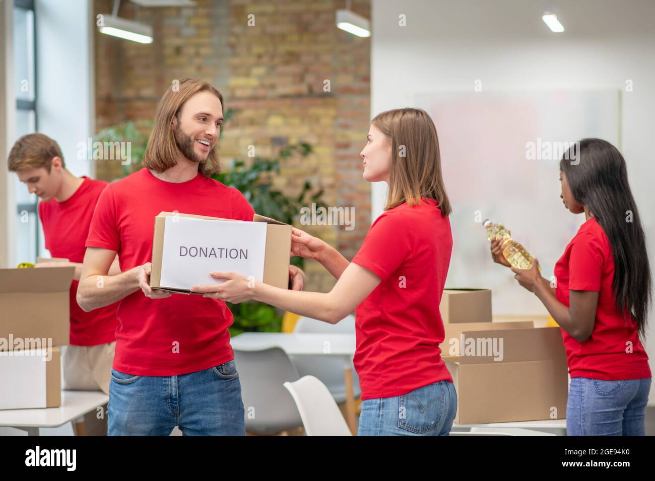 Young people working as volunteers and packing the boxes Stock Photo ...