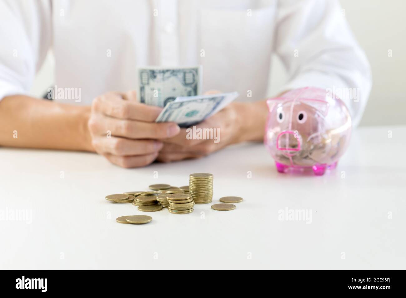 Focus on the coins with the background a man counting the money concept ...