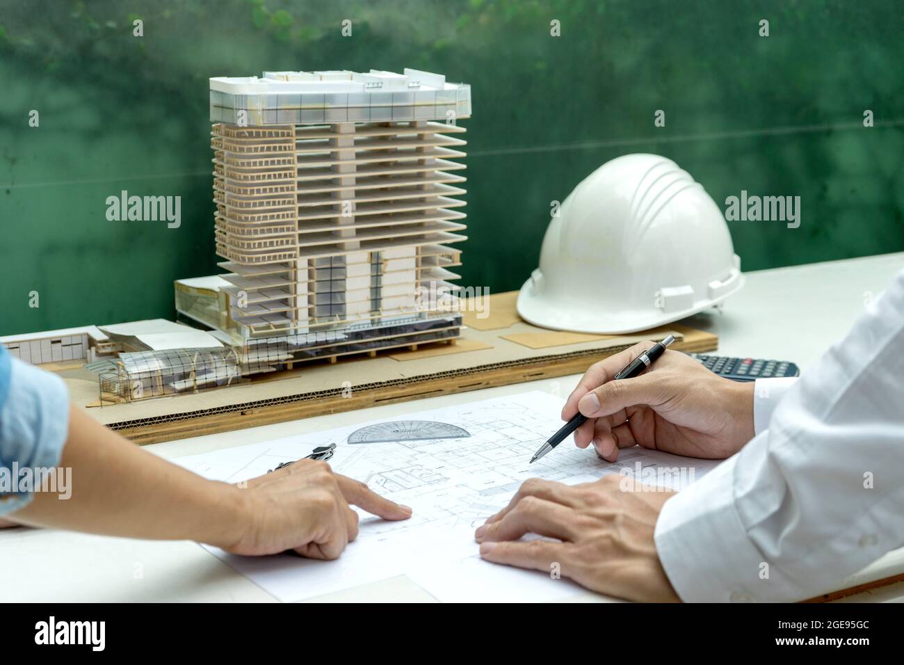 Engineers and architects are discussing and revising plans for building ...