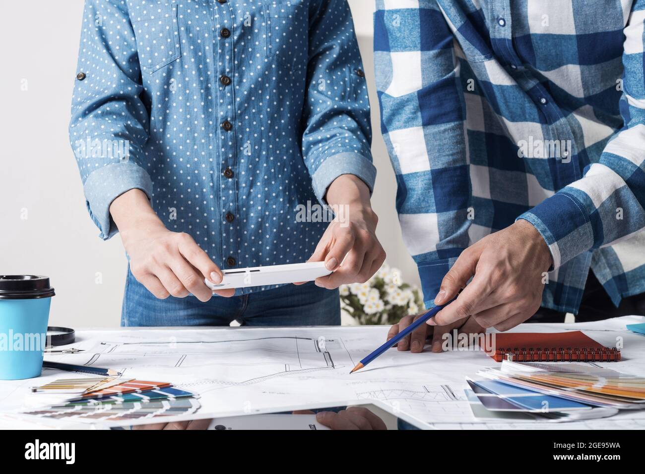 Woman taking photo of technical drawing Stock Photo - Alamy