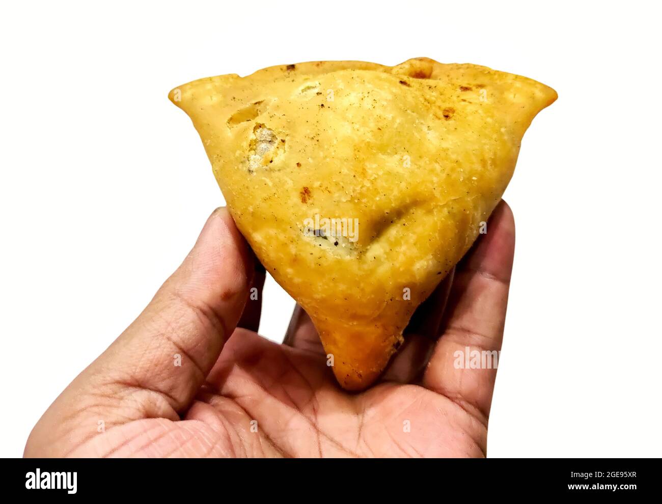 A man holding fried samosa in hand isolated on white background Stock ...