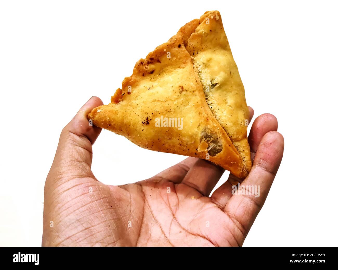 A man holding fried samosa in hand isolated on white background Stock ...