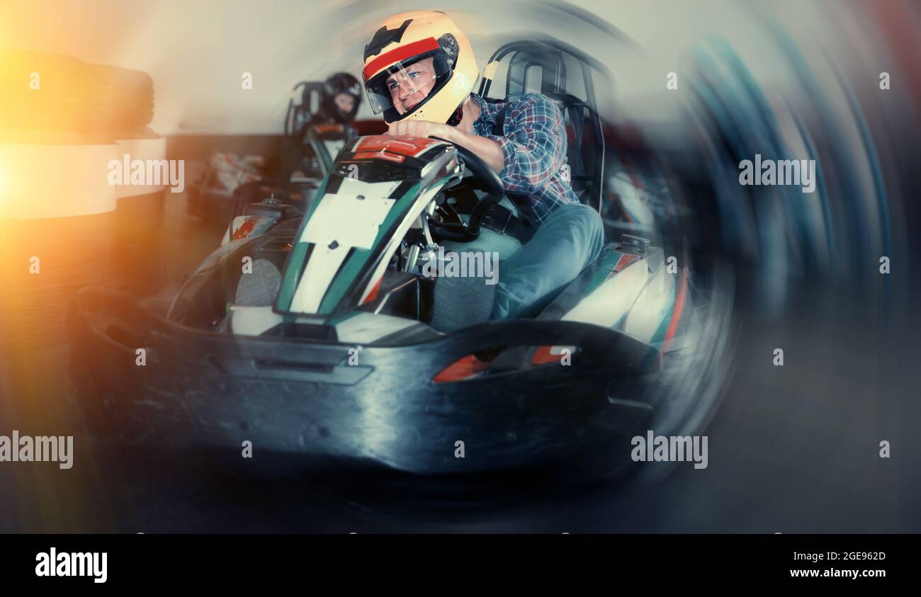 Portrait of adult man driving racing car at kart circuit Stock Photo ...